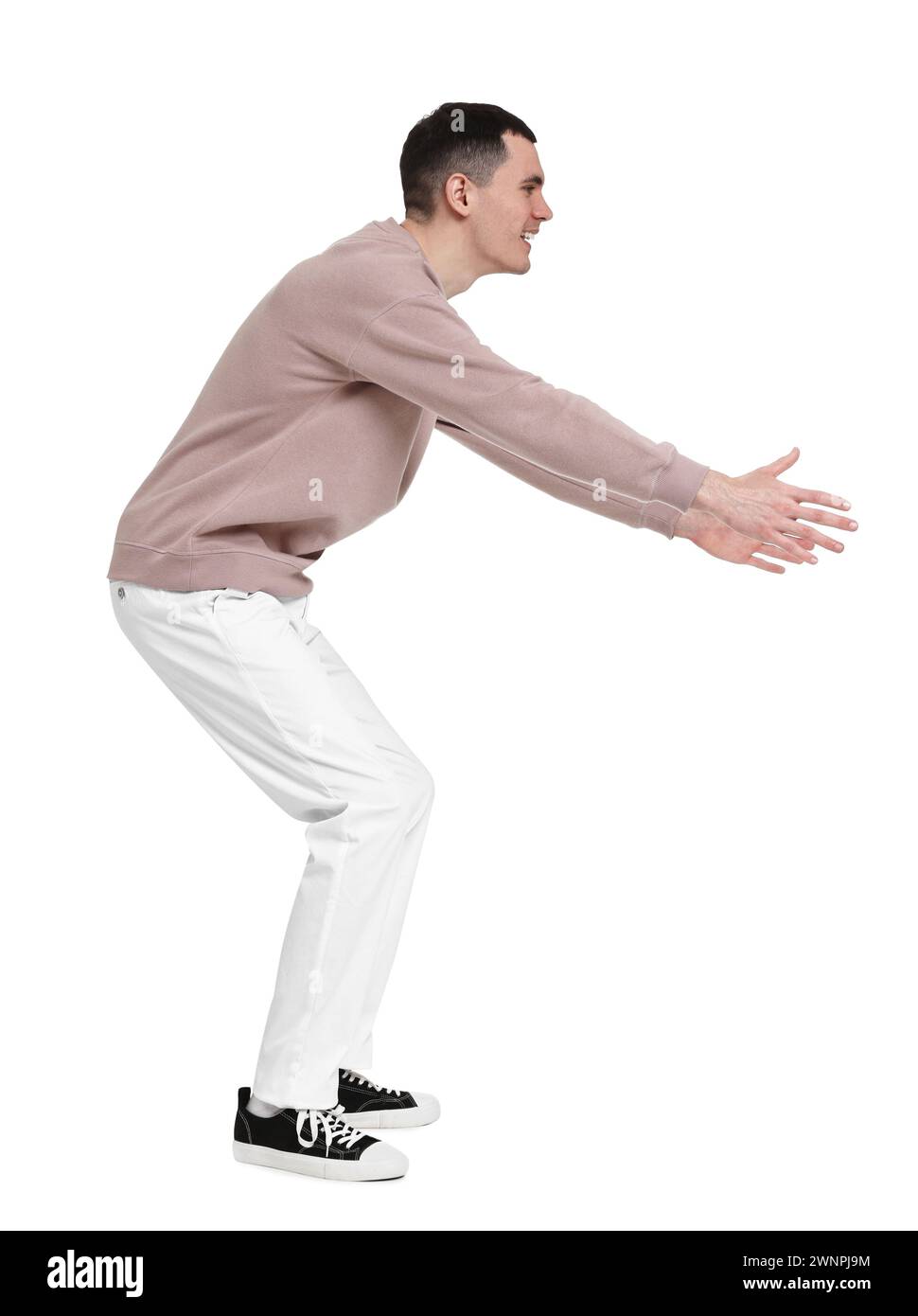 Handsome young man greeting someone on white background Stock Photo - Alamy