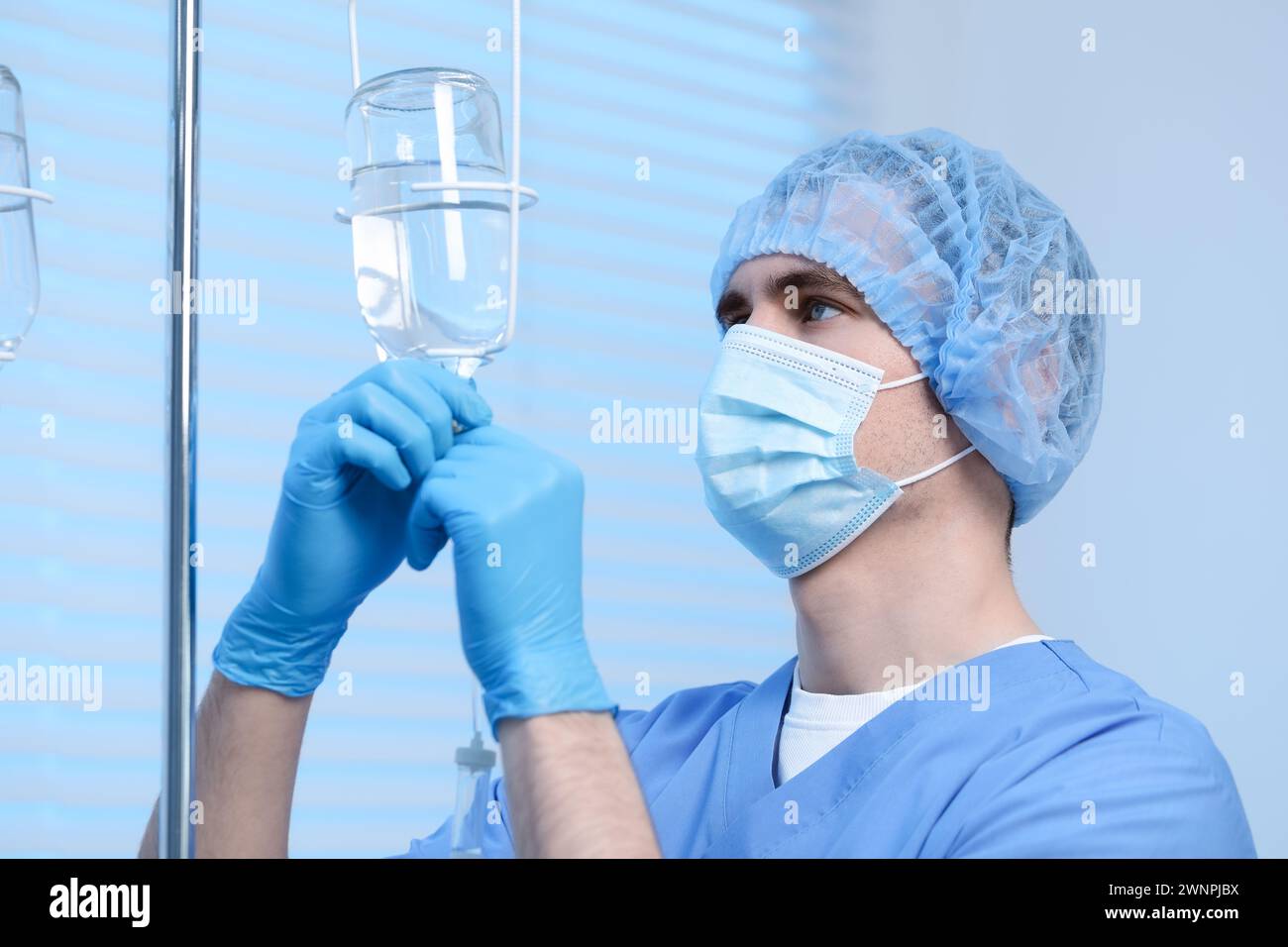 Doctor setting up iv hi-res stock photography and images - Alamy