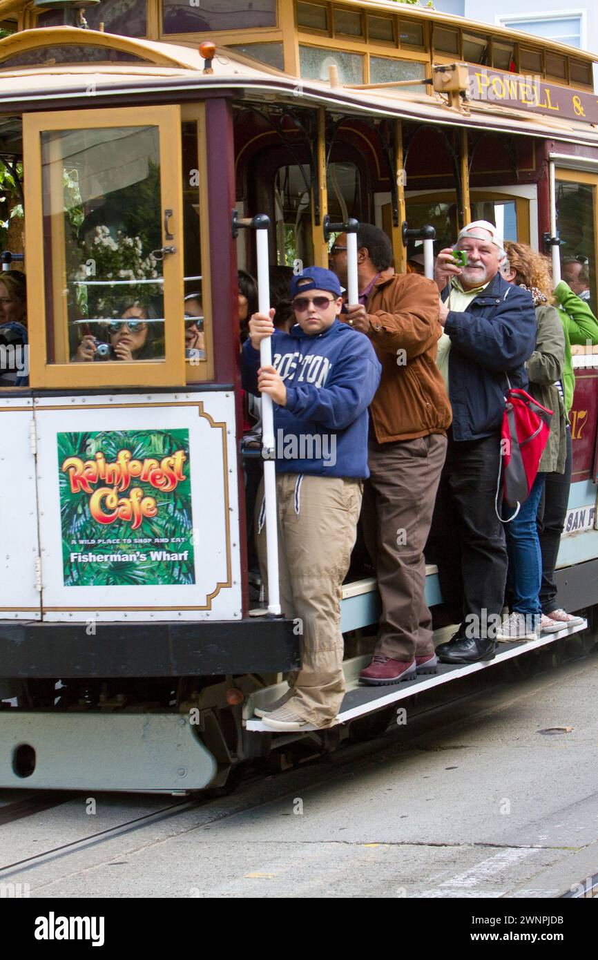 Riders on San Francisco's famous cable cars Stock Photo - Alamy