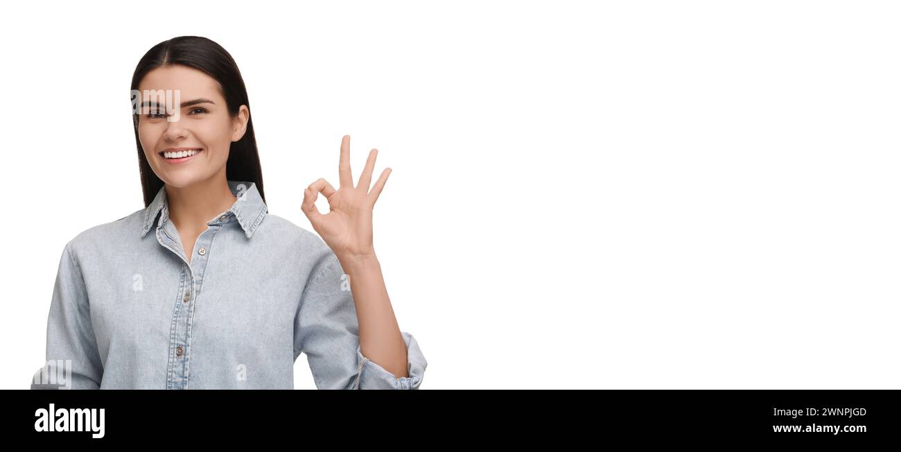Woman with clean teeth smiling and showing ok gesture on white ...
