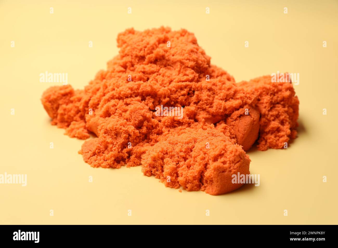 Pile of orange kinetic sand on beige background, closeup Stock Photo ...