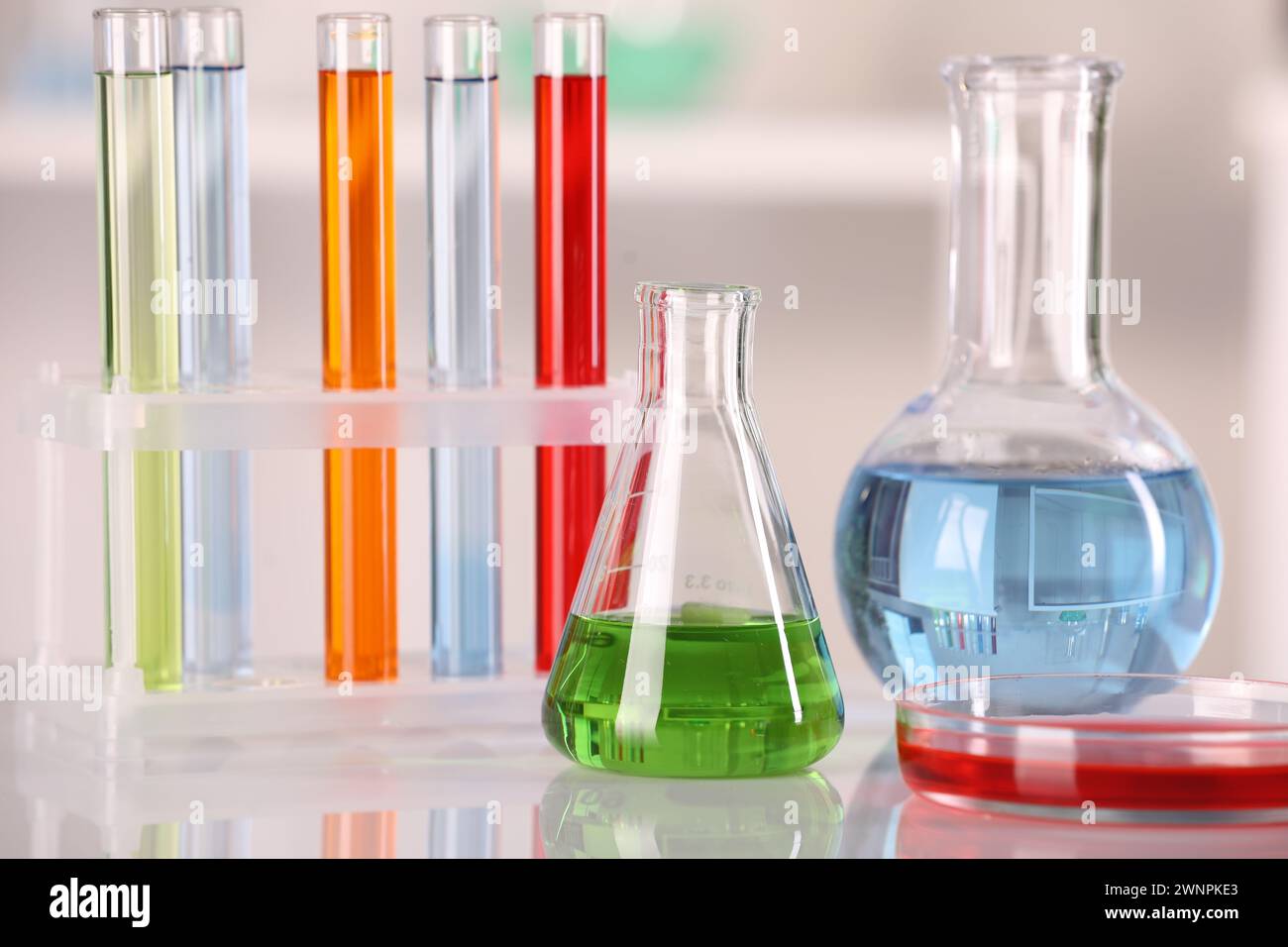 Laboratory analysis. Glass flasks, Petri dish and test tubes with ...