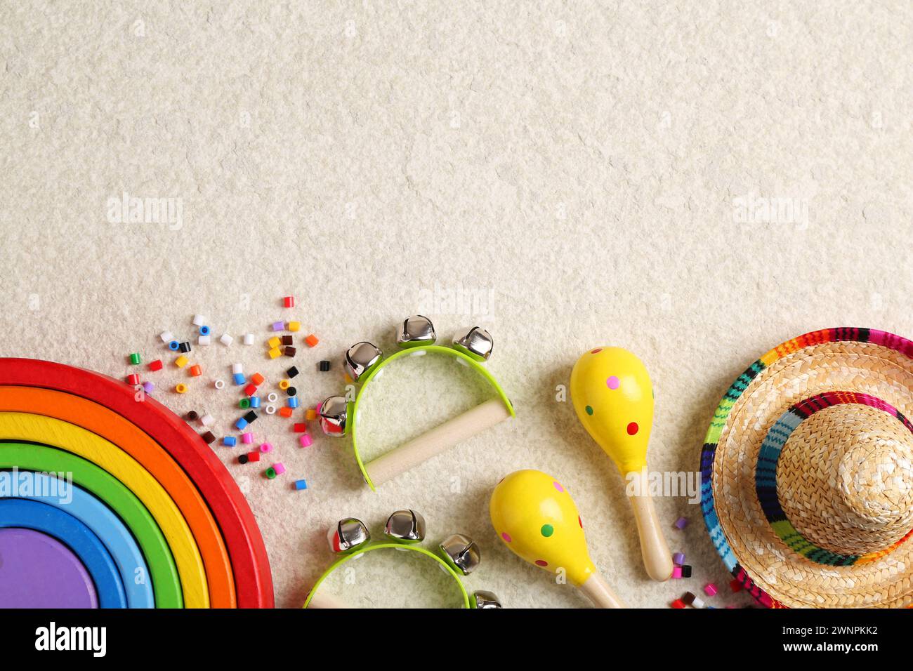 Baby song concept. Kids musical instruments and toys on beige carpet ...