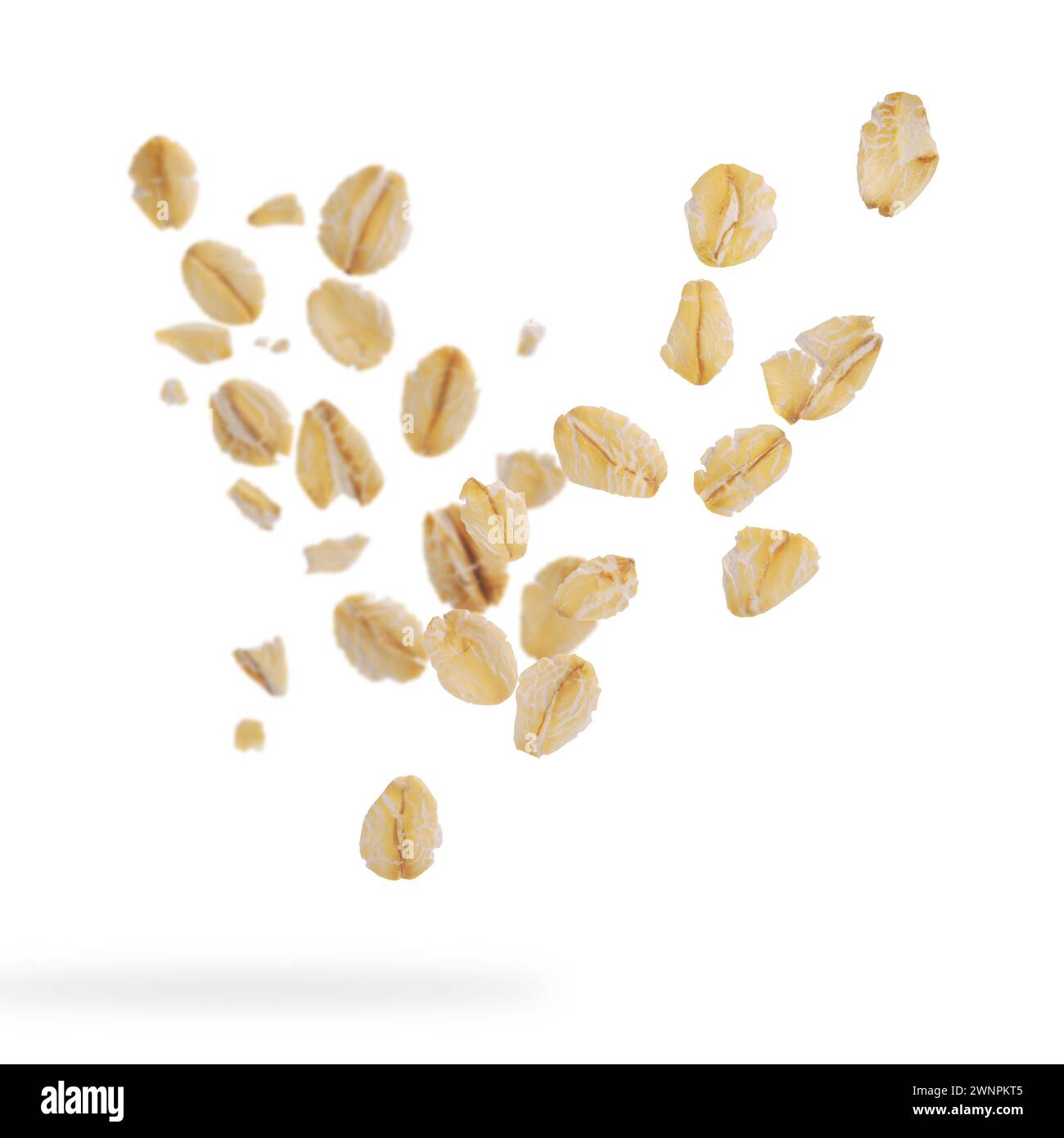 Rolled oat flakes falling on white background Stock Photo - Alamy