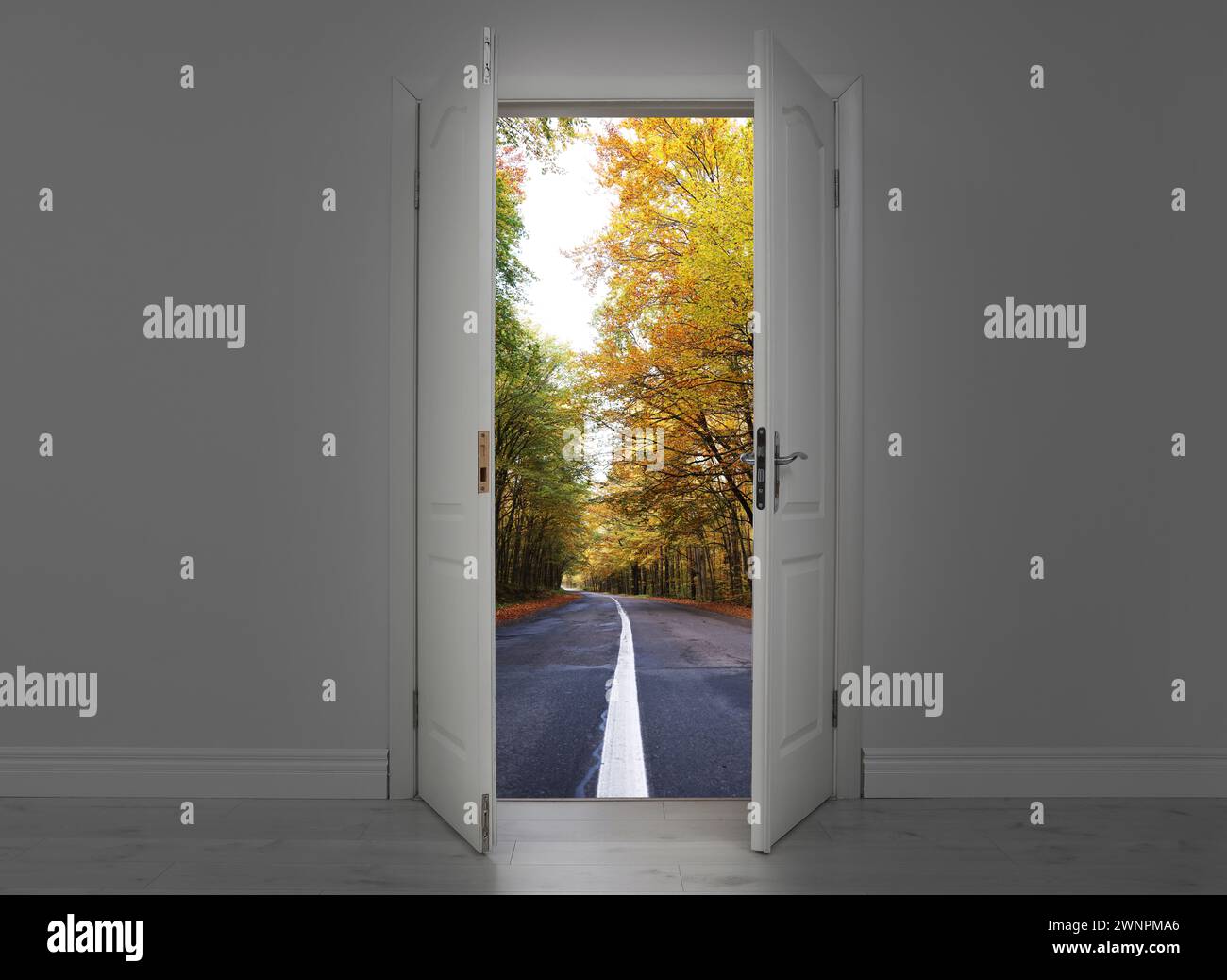 Open door in brick wall inviting to road Stock Photo - Alamy