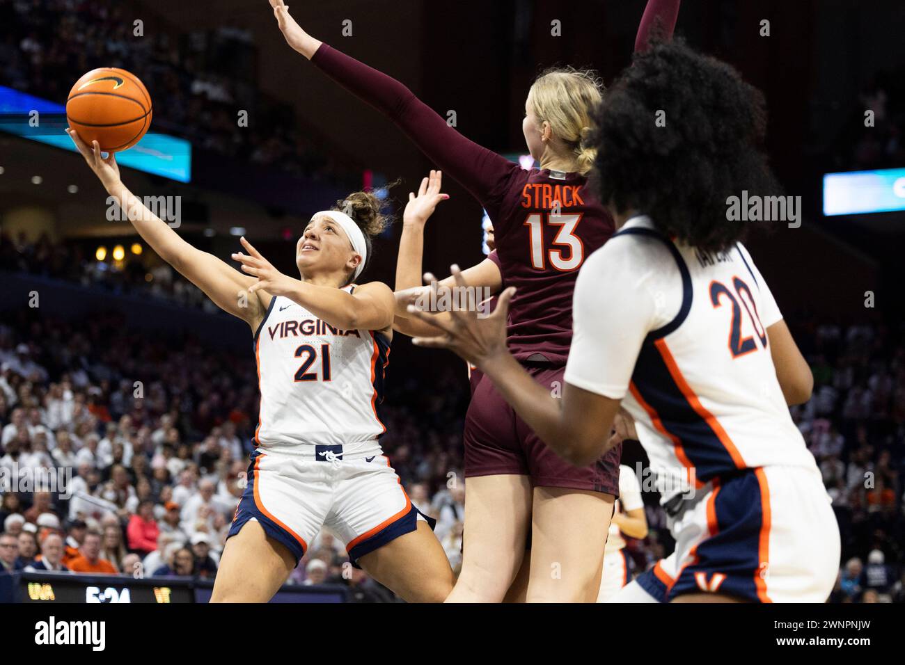 Virginia's Kymora Johnson (21) shoots past Virginia Tech's Clara Strack ...