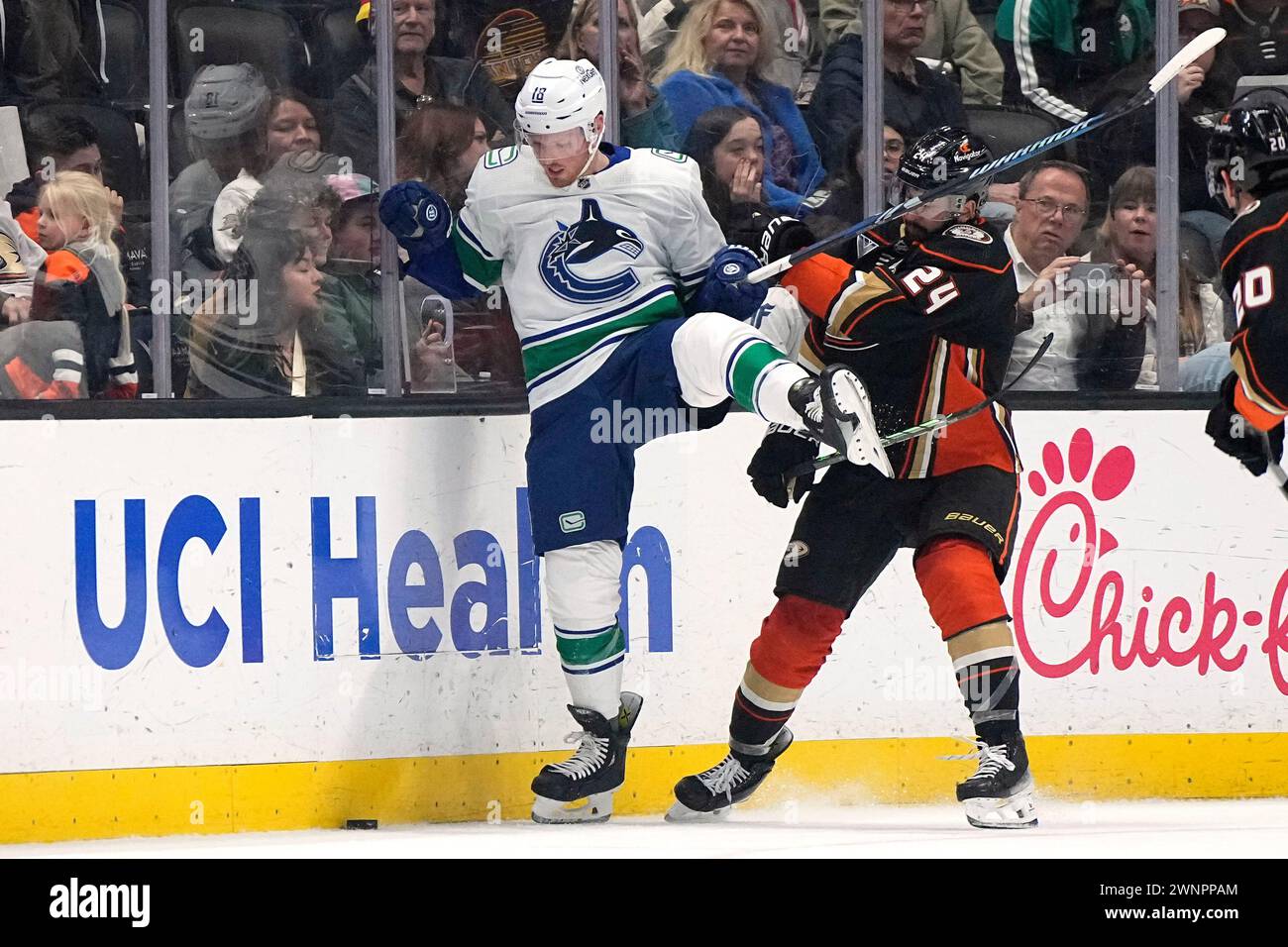 Vancouver Canucks center Sam Lafferty, left, battles for the puck with ...