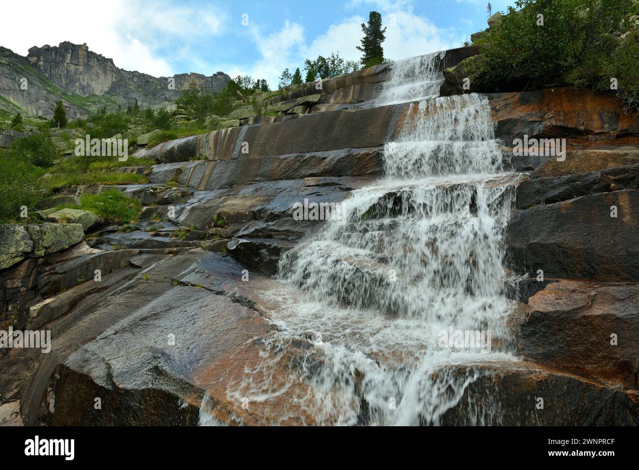 The stone steps of the mountain form a waterfall for a stormy mountain ...