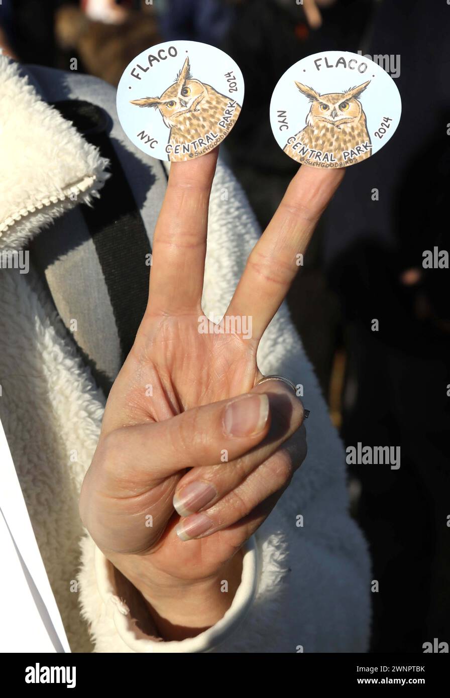 New York, New York, USA. 3rd Mar, 2024. A mourner holds Flaco stickers ...