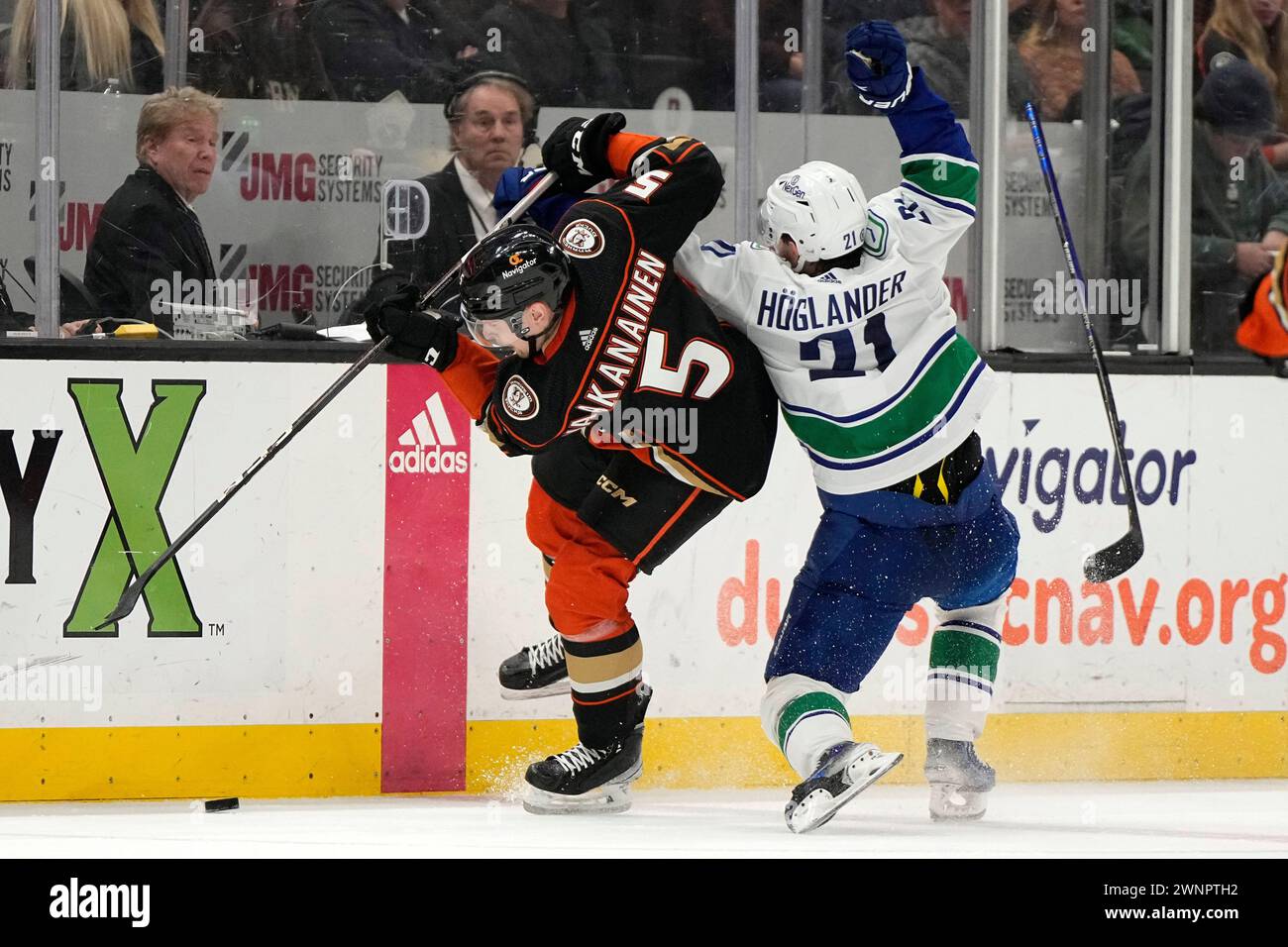 Vancouver Canucks left wing Nils Hoglander, right, breaks his stick as ...