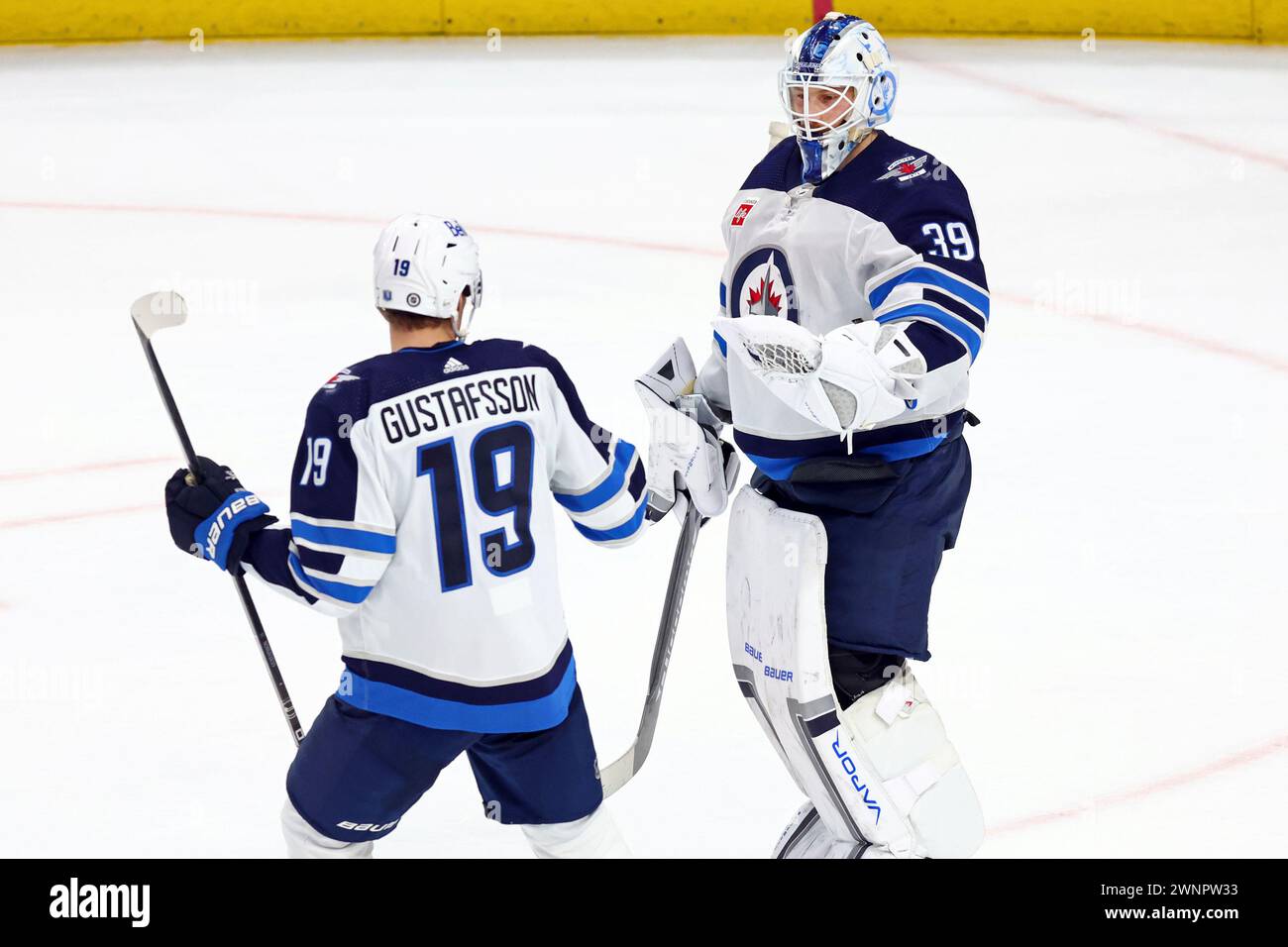 Winnipeg Jets center David Gustafsson (19) and goaltender Laurent ...