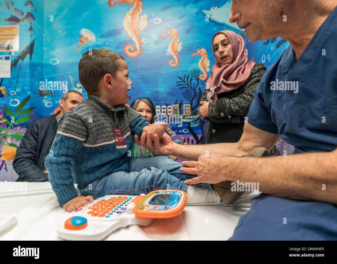 Four-year-old Omar Abu Kuwaik cries as orthopedic surgeon Dr. Scott ...