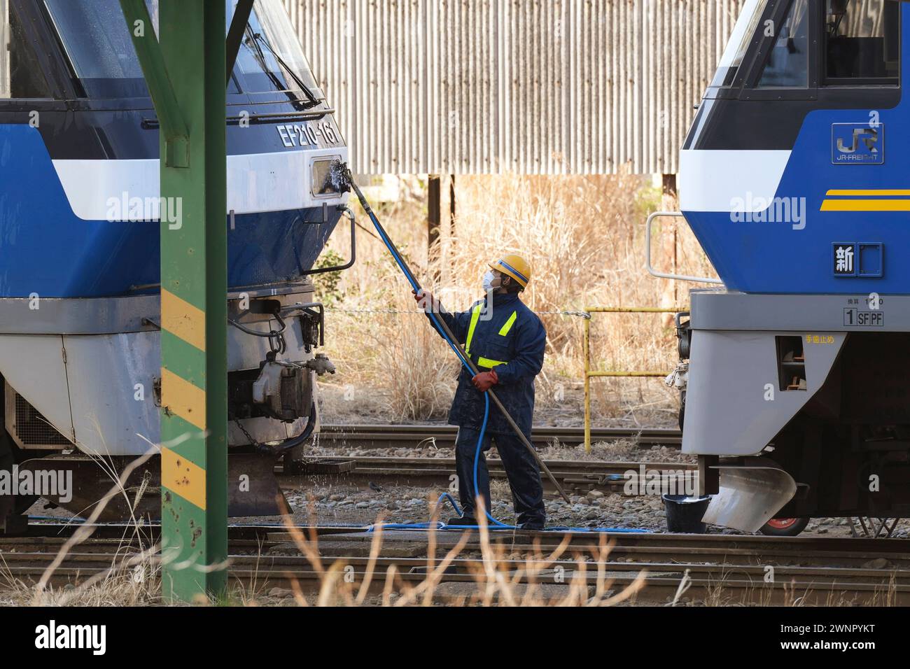 A railroad crew washes a train at a locomotive depot Monday, March 4 ...