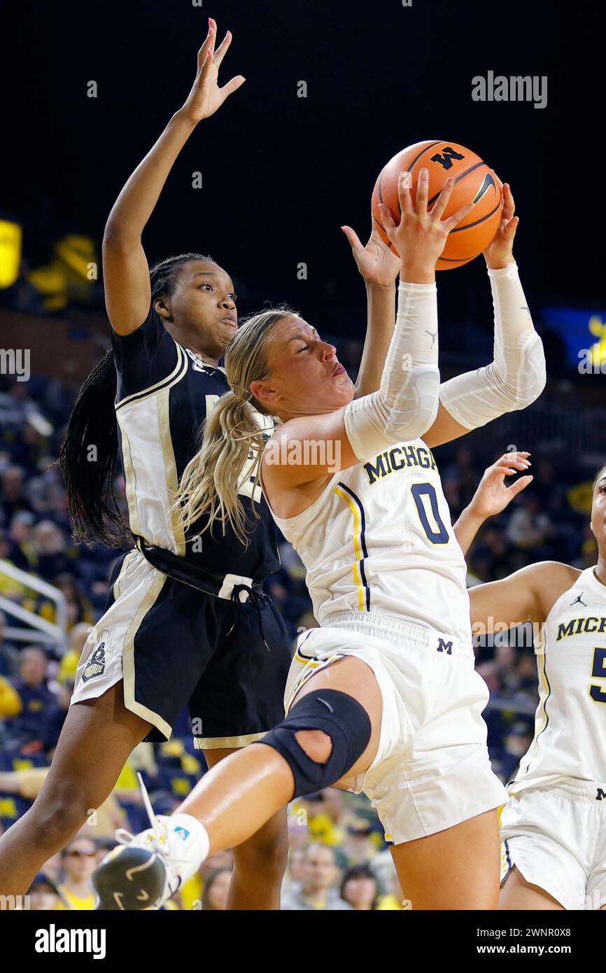 Michigan guard Elissa Brett (0), right, pulls down a rebound against ...