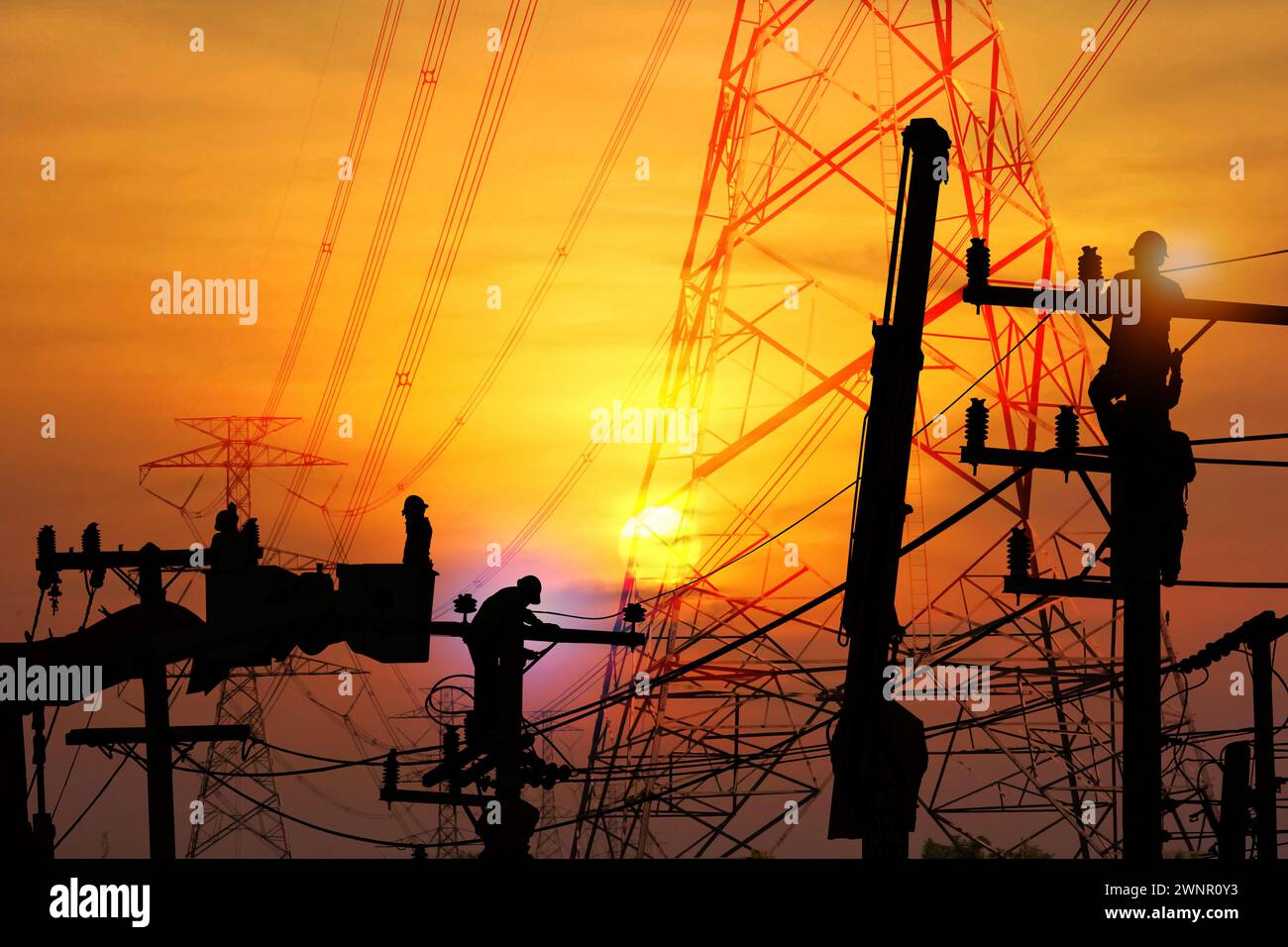 group of silhouette electric worker working on pole connected high ...