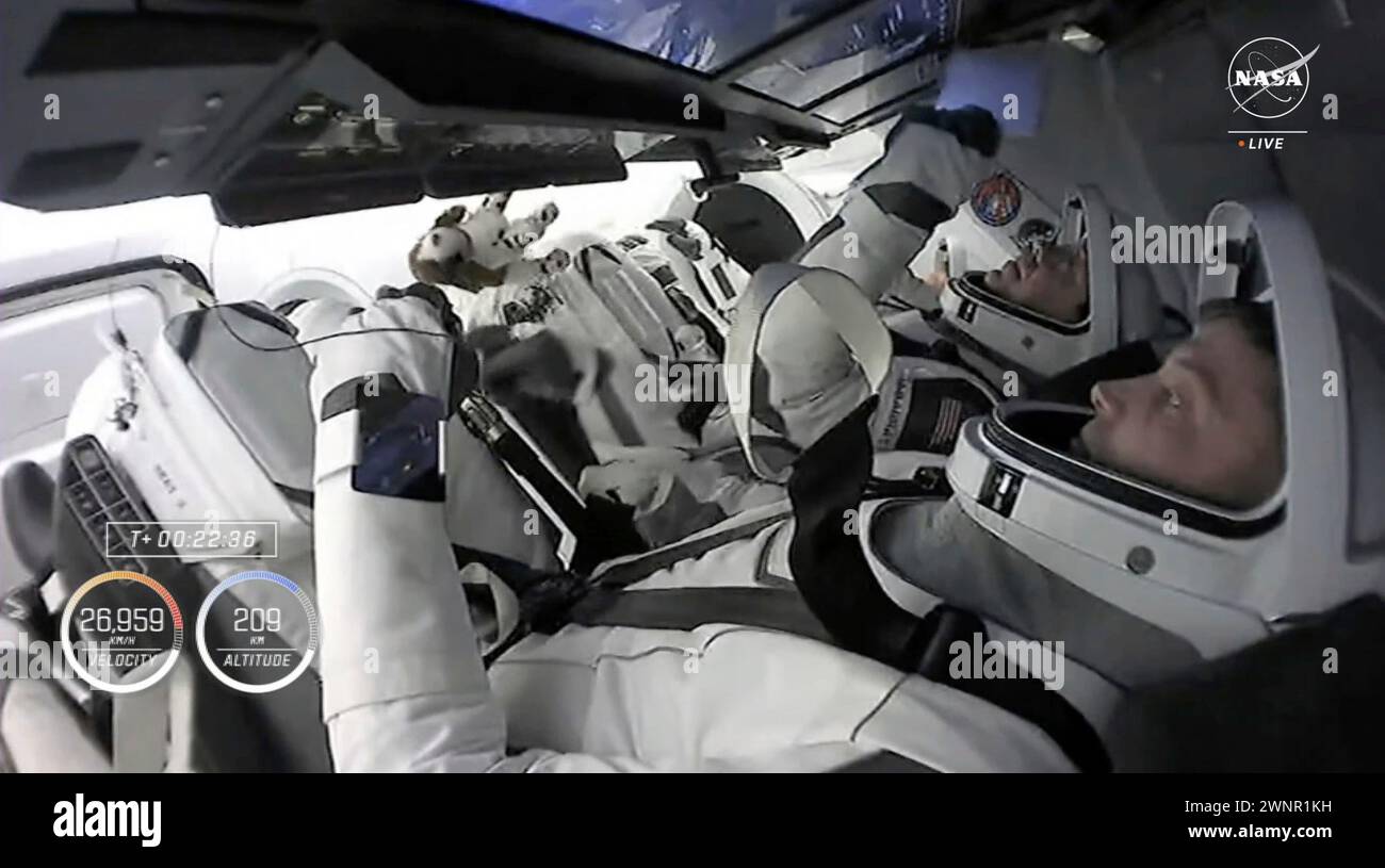 In this image taken from NASA video, commander Matthew Dominick, bottom ...