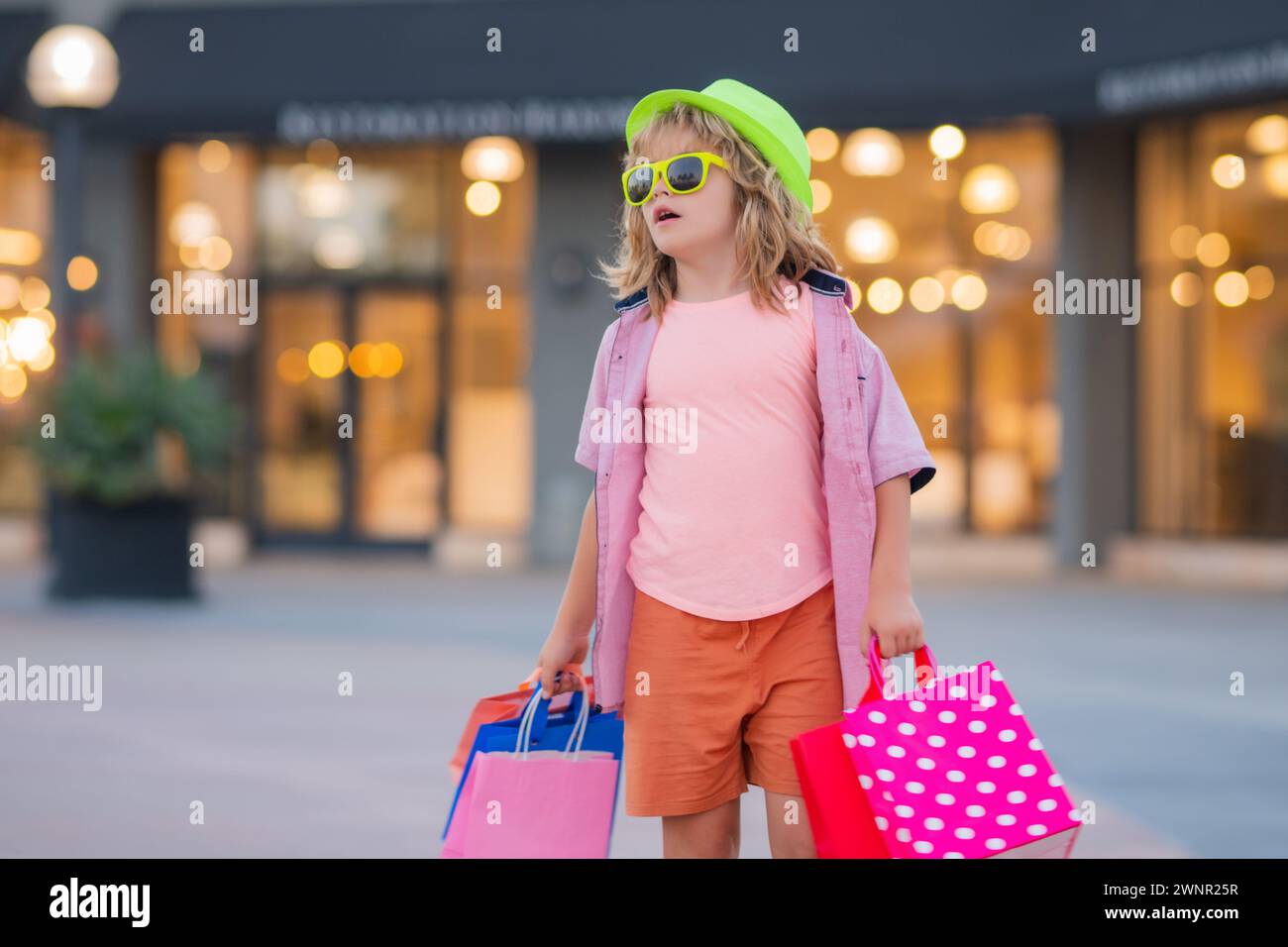 Fashion child with shopping bag outdoor. Trend kids look, outfit ...
