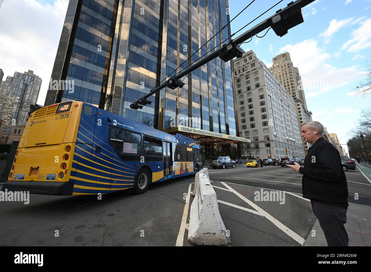 An MTA bus drives under a gantry supporting license plate and E-Z Pass ...