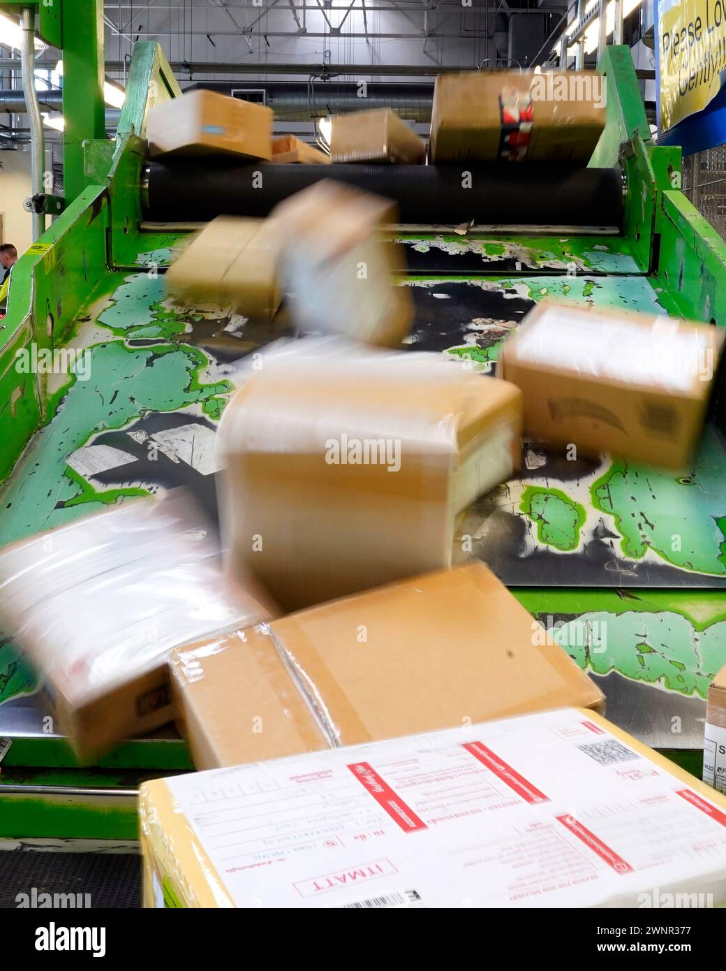 Parcels slide down a ramp after being scanned at the U.S. Customs and ...