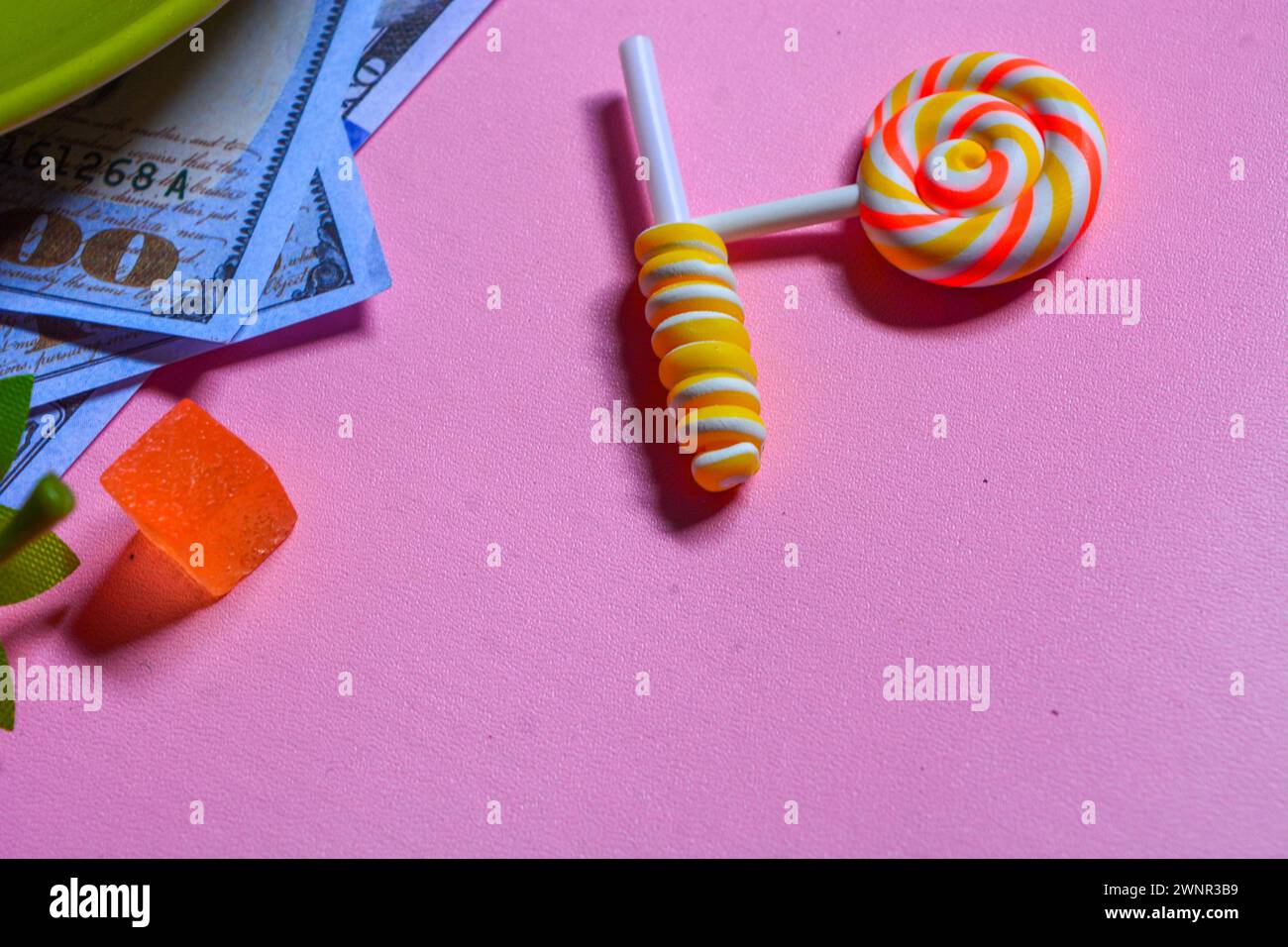 Little candies on a pink background Stock Photo - Alamy