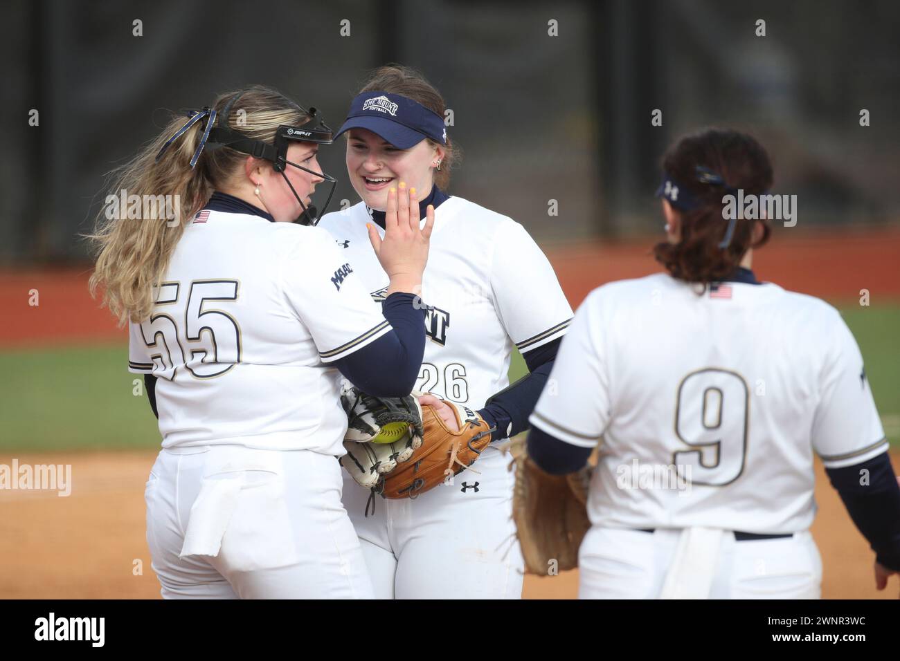 Mount St. Mary's infielder Hannah Gartrell (26) talks with pitcher ...
