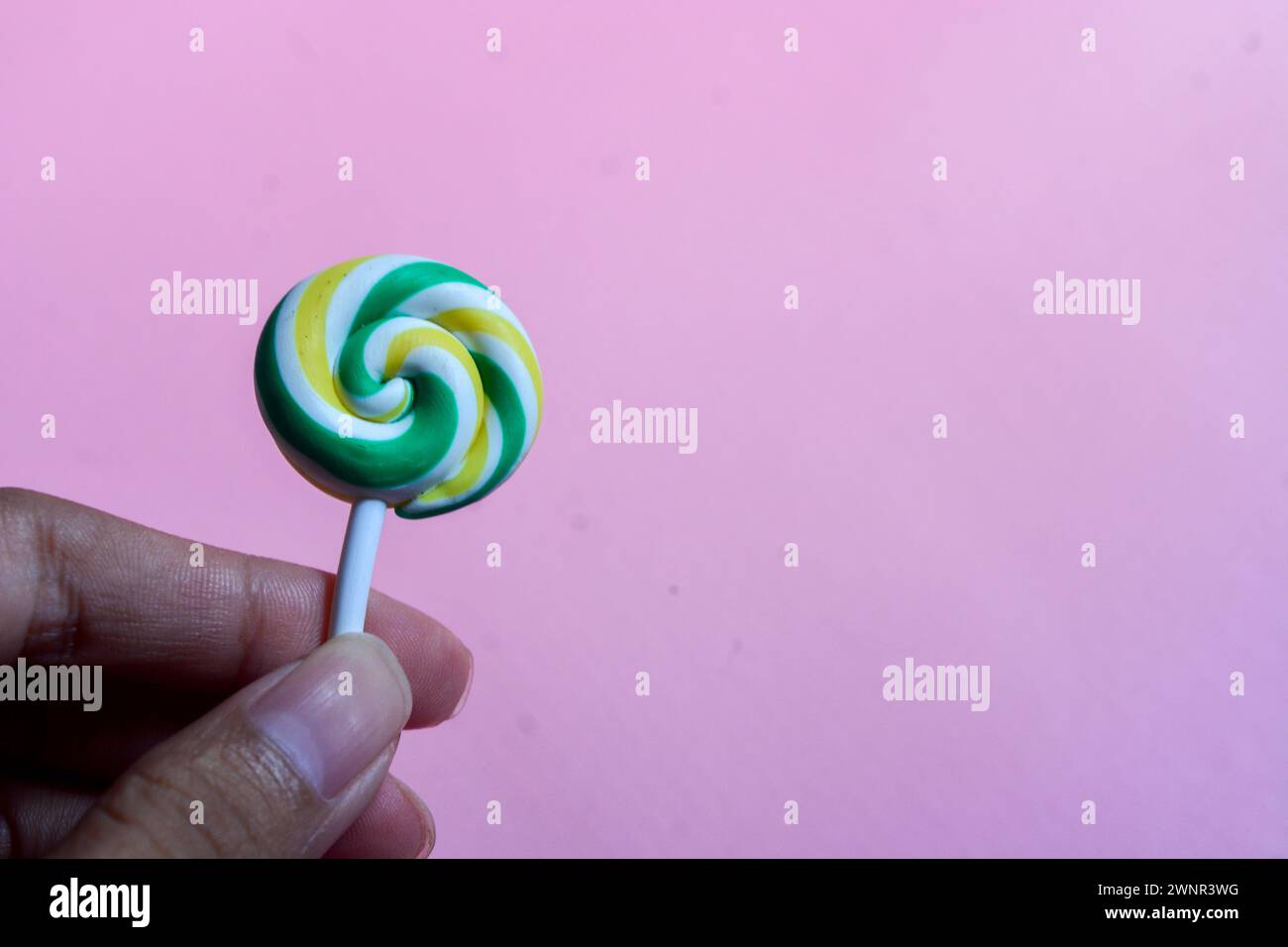 Little candies on a pink background Stock Photo - Alamy