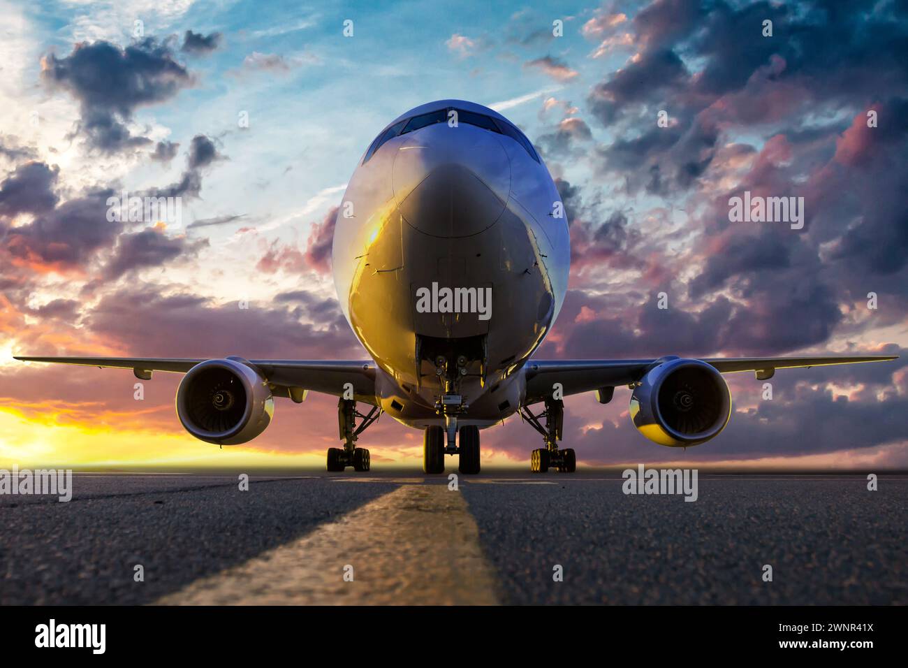 Front view of the wide body passenger jet plane at the airport apron ...