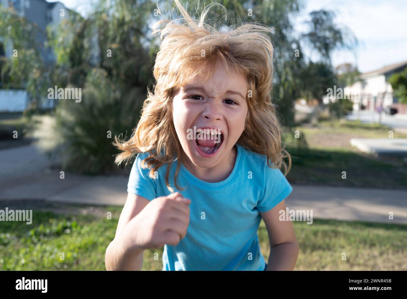 Enraged kid boy with angry expression. Angry hateful little rage boy ...