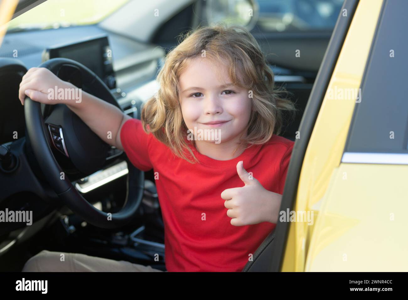 Little Driver. Cute little boy pretending to drive. Kid in car with his ...
