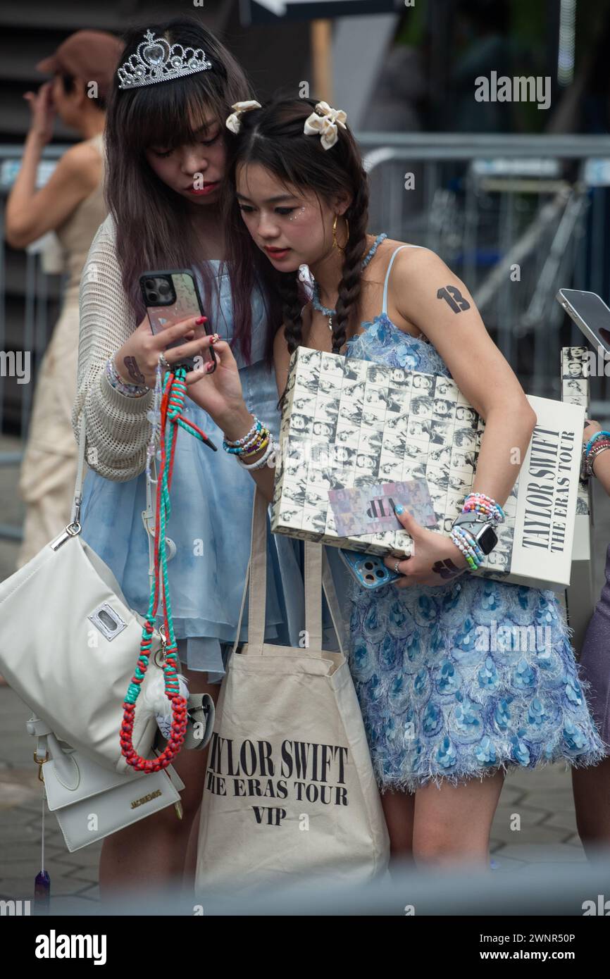 2 March 2024. Fans holding merchandise at Taylor Swift The Eras Tour ...