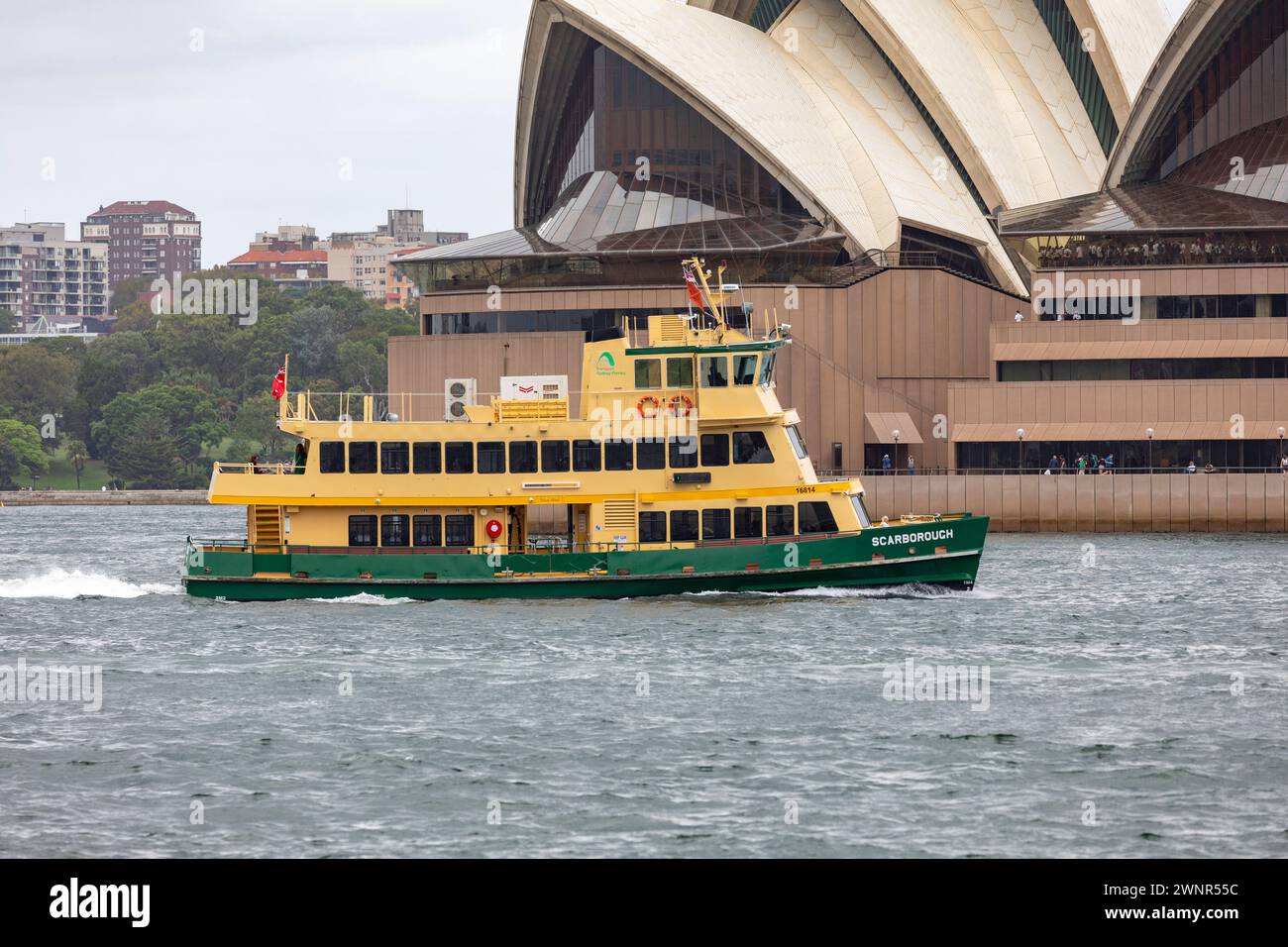 Sydney Opera house building with Sydney ferry Scarborough passing by on ...