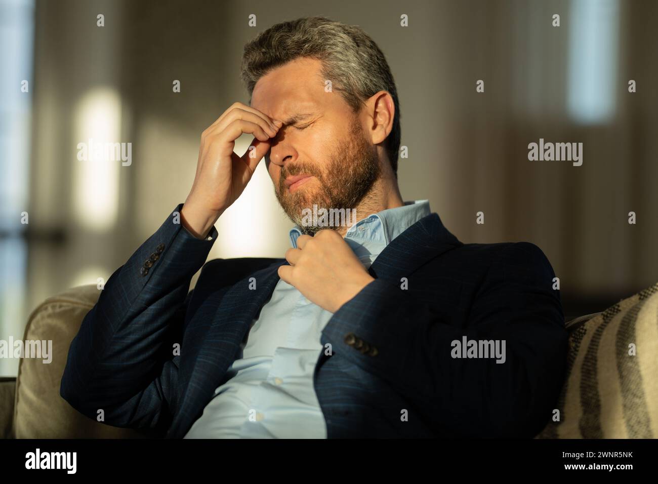 Man with sinus headache, tension or cluster headache, close up portrait ...