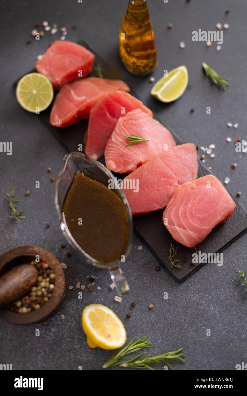 Pieces of Fresh tuna Fish fillet and soy sauce marinade in a glass bowl ...