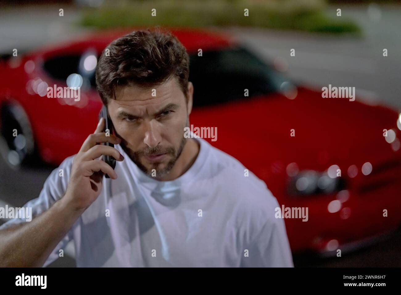 Gangster call phone. Angry man chatting on phone near car on night ...