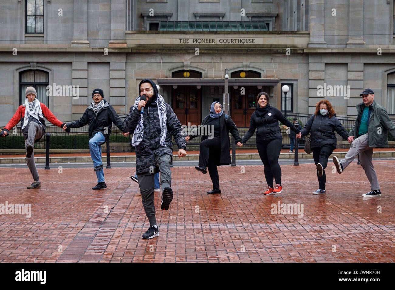 A member of Jafra Dabke Team teaches the public how to dance it. About ...