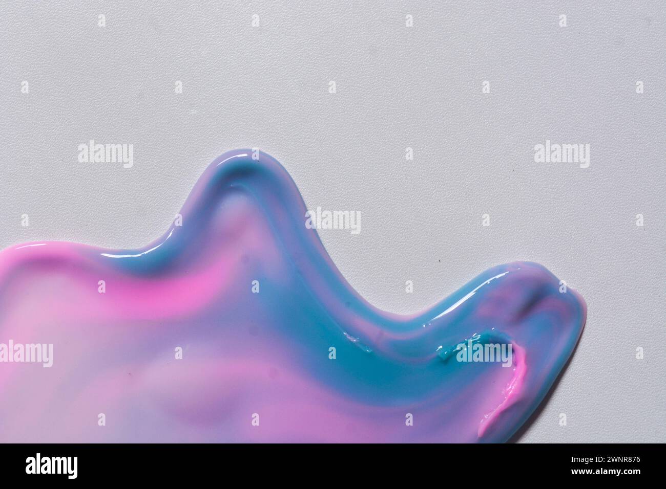 Colorful leaking paint liquid spills from close range Stock Photo - Alamy