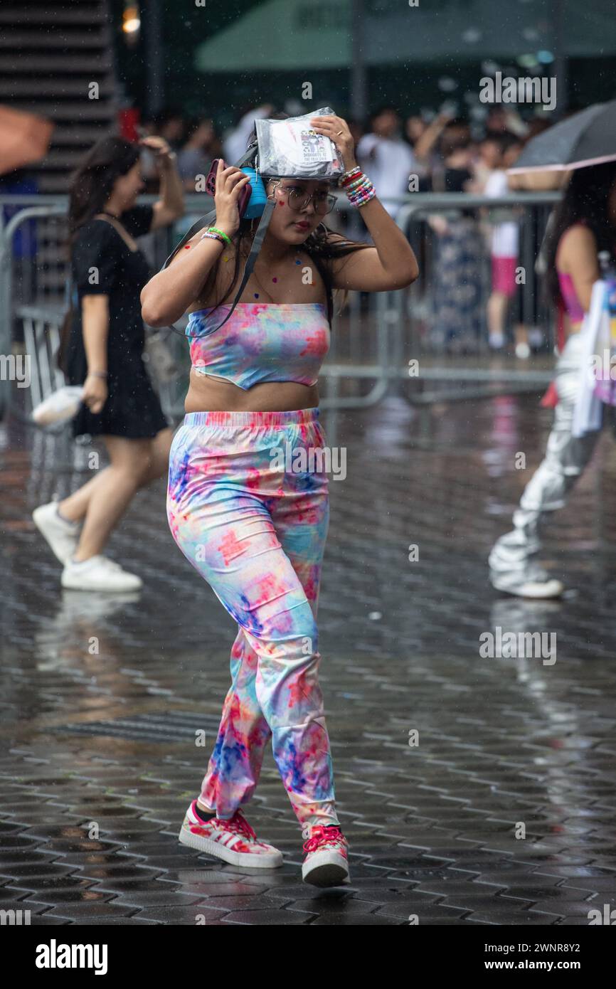 3 March 2024. A female fan dress tie dye clothes walking under the ...