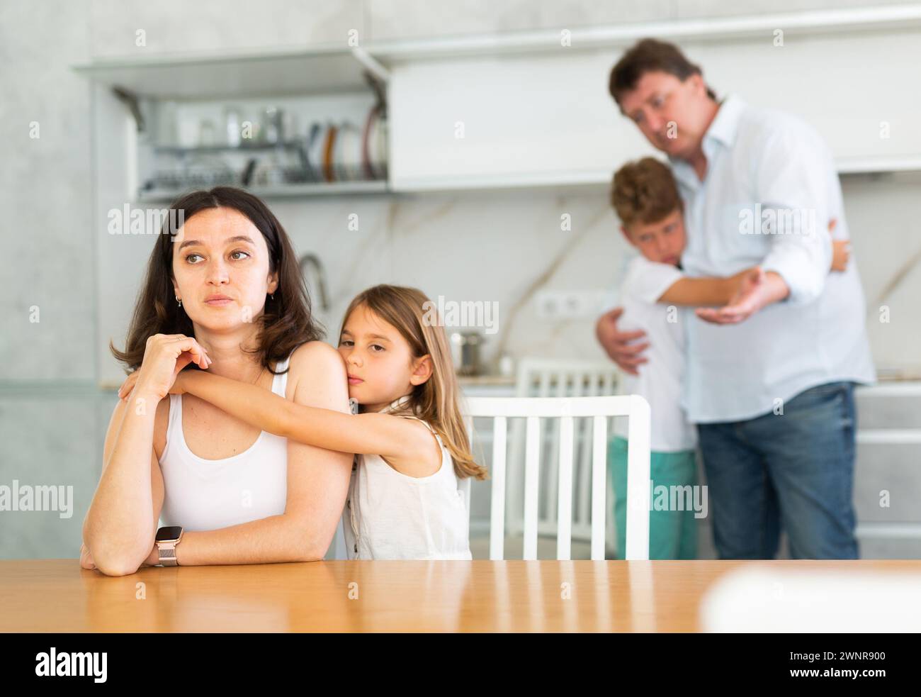 Family with two children in kitchen during quarrel Stock Photo - Alamy