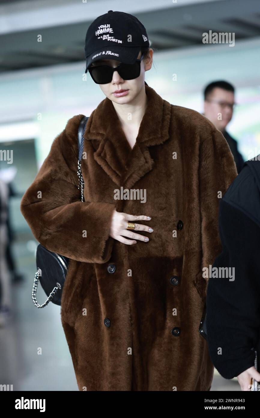 Chinese singer and actress Stephy Qi appears at the airport in Beijing ...