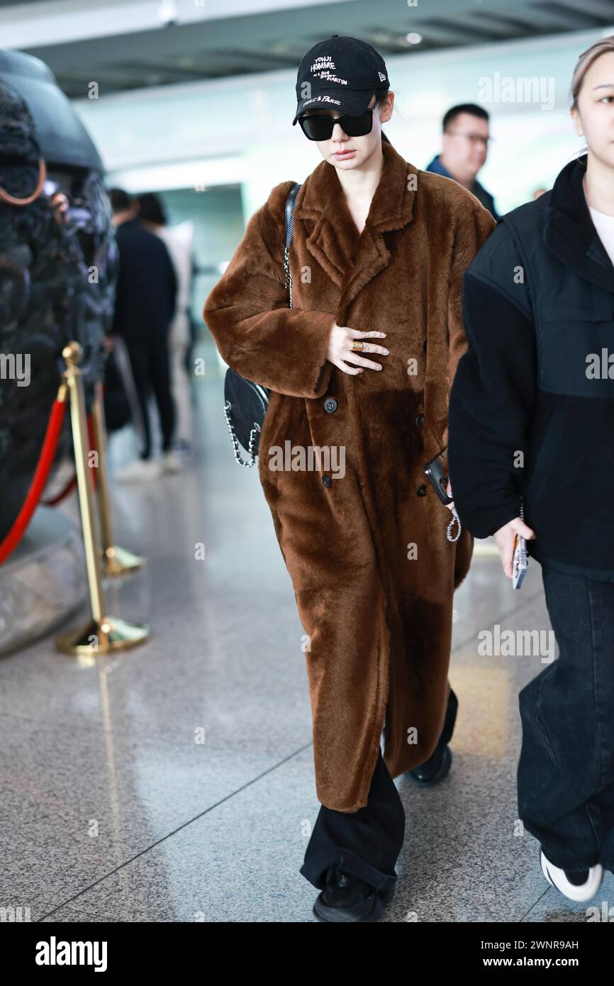 Chinese singer and actress Stephy Qi appears at the airport in Beijing ...