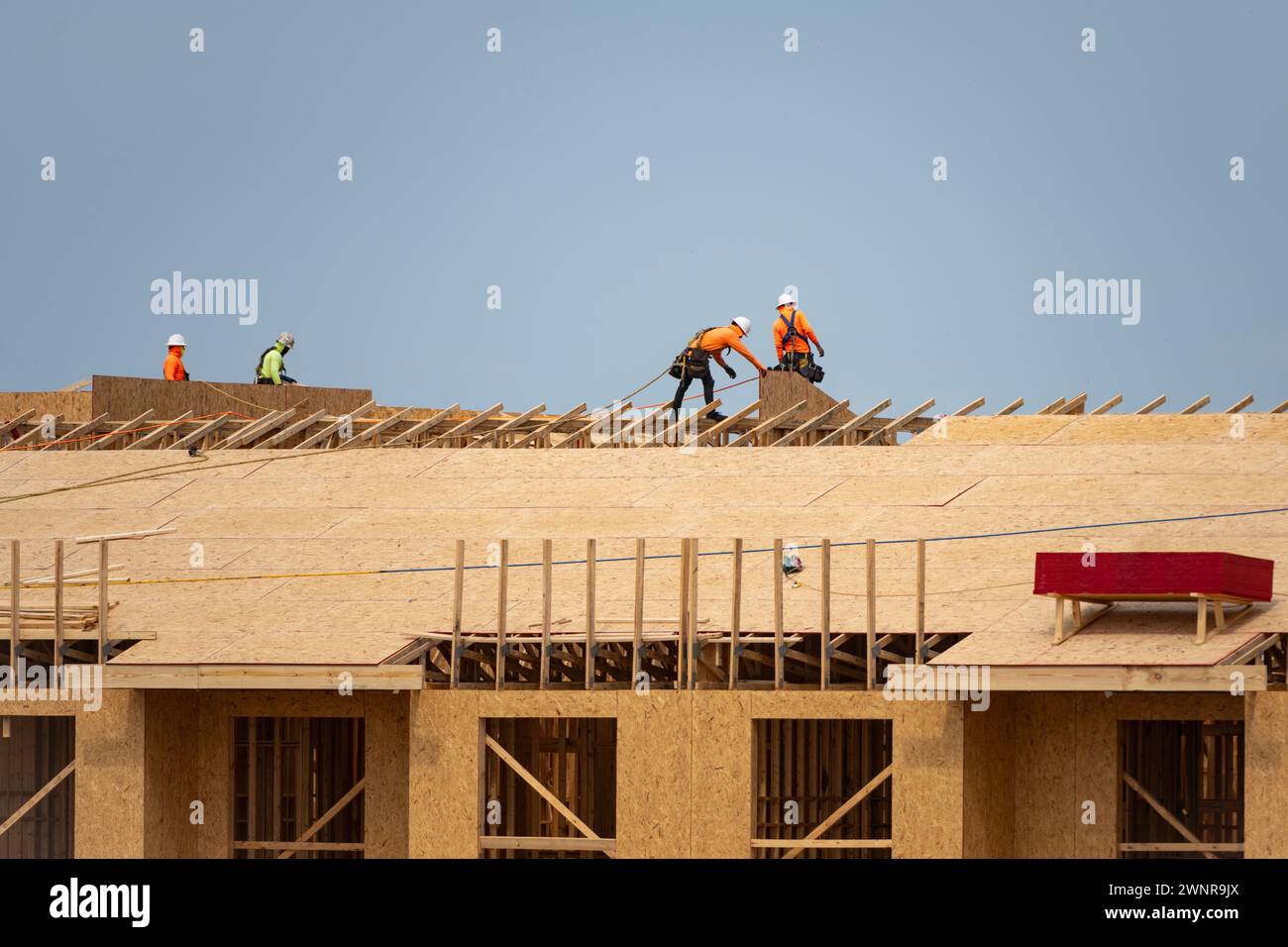 Wooden roof. Roofs repair. Roofer worker install new roof on top roof ...