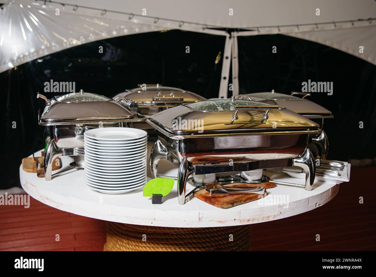 Elegant buffet setup featuring stainless steel chafing dishes and ...