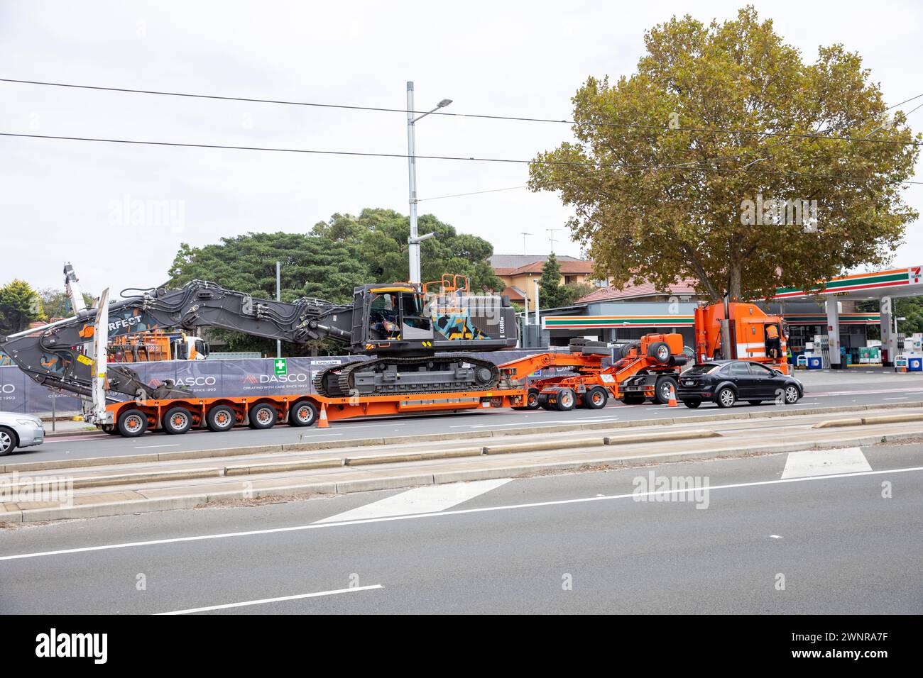 Oversize low loading vehicle transports a construction excavator digger ...