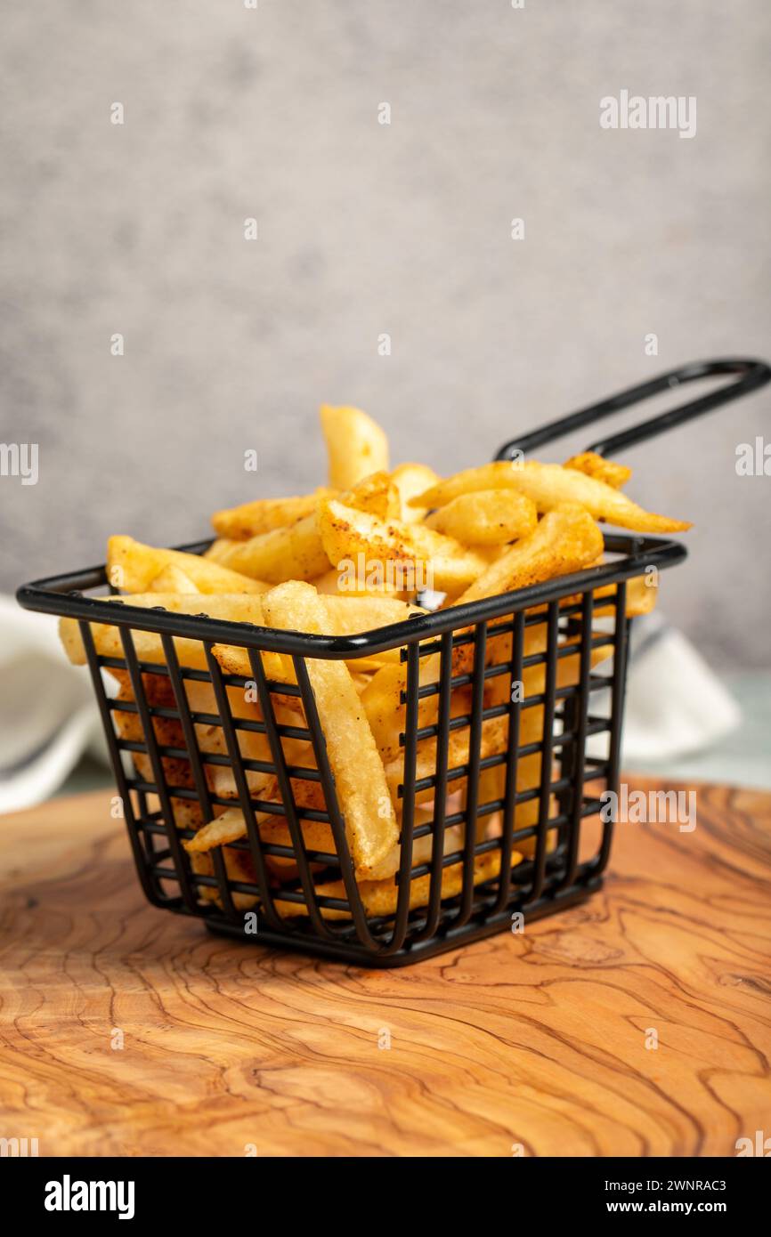 French fries. Spicy French fries on serving board. Close up Stock Photo ...