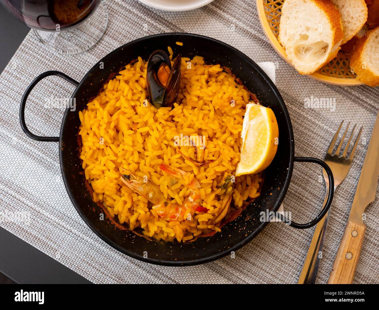 Spanish rice dish paella tinted with saffron. Prepared with olive oil ...