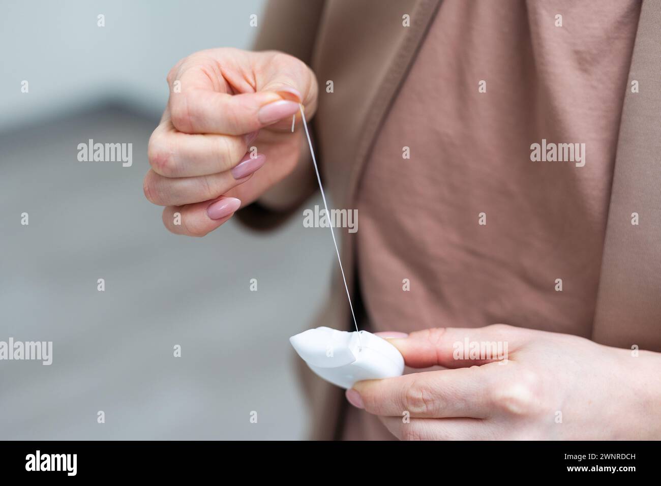 Hands person floss teeth hi-res stock photography and images - Alamy