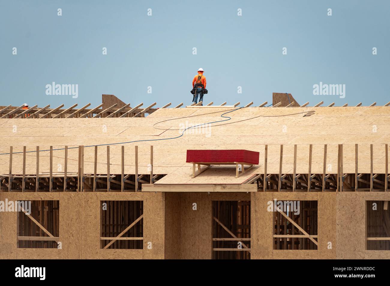 Wooden roof. Roofs repair. Roofer worker install new roof on top roof ...