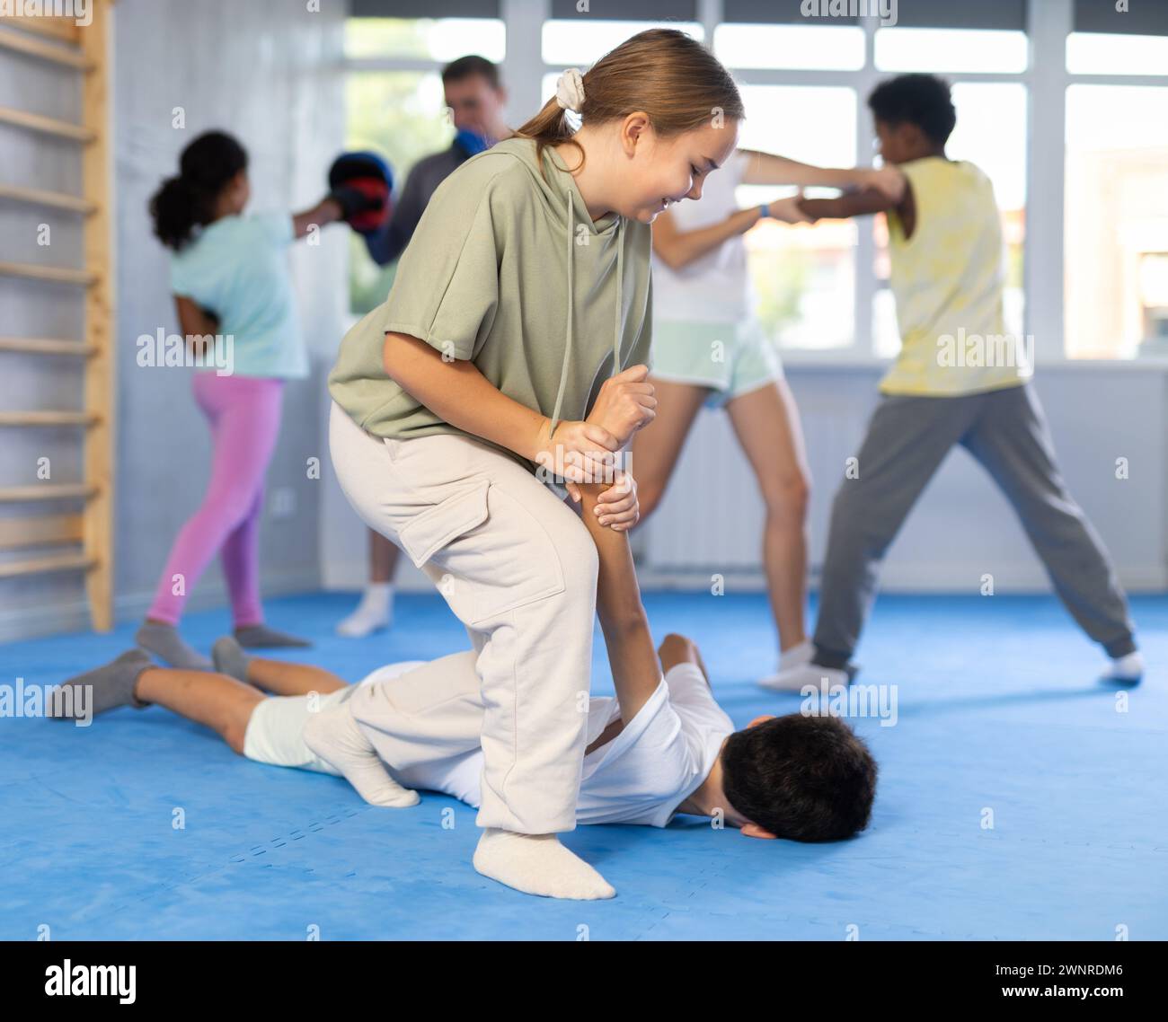 Self-defense - girl twists the arm of an attacking boy during self ...