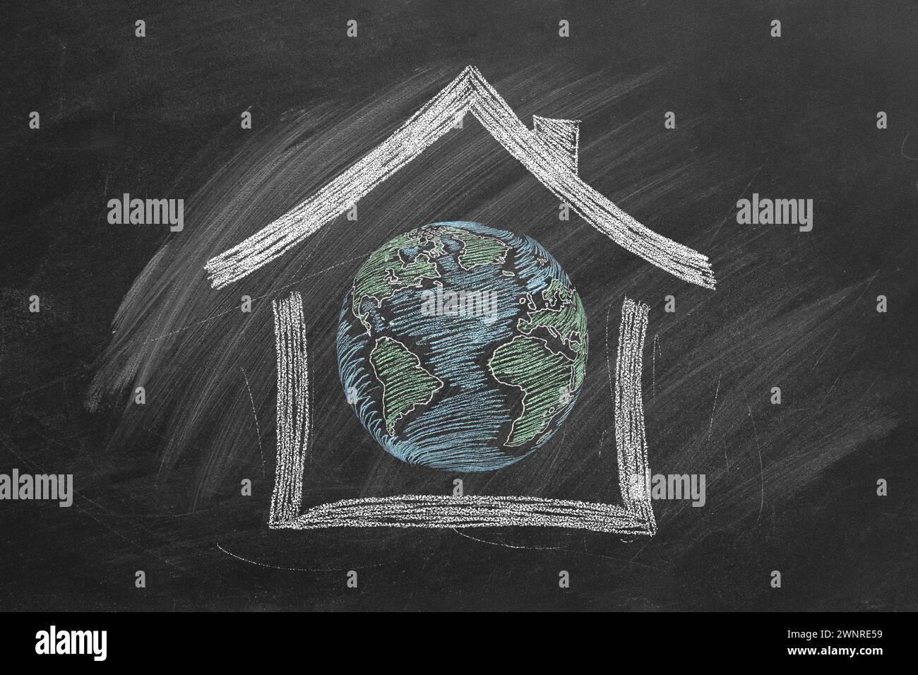 A house is drawn on a blackboard with chalk with a globe inside. Take ...