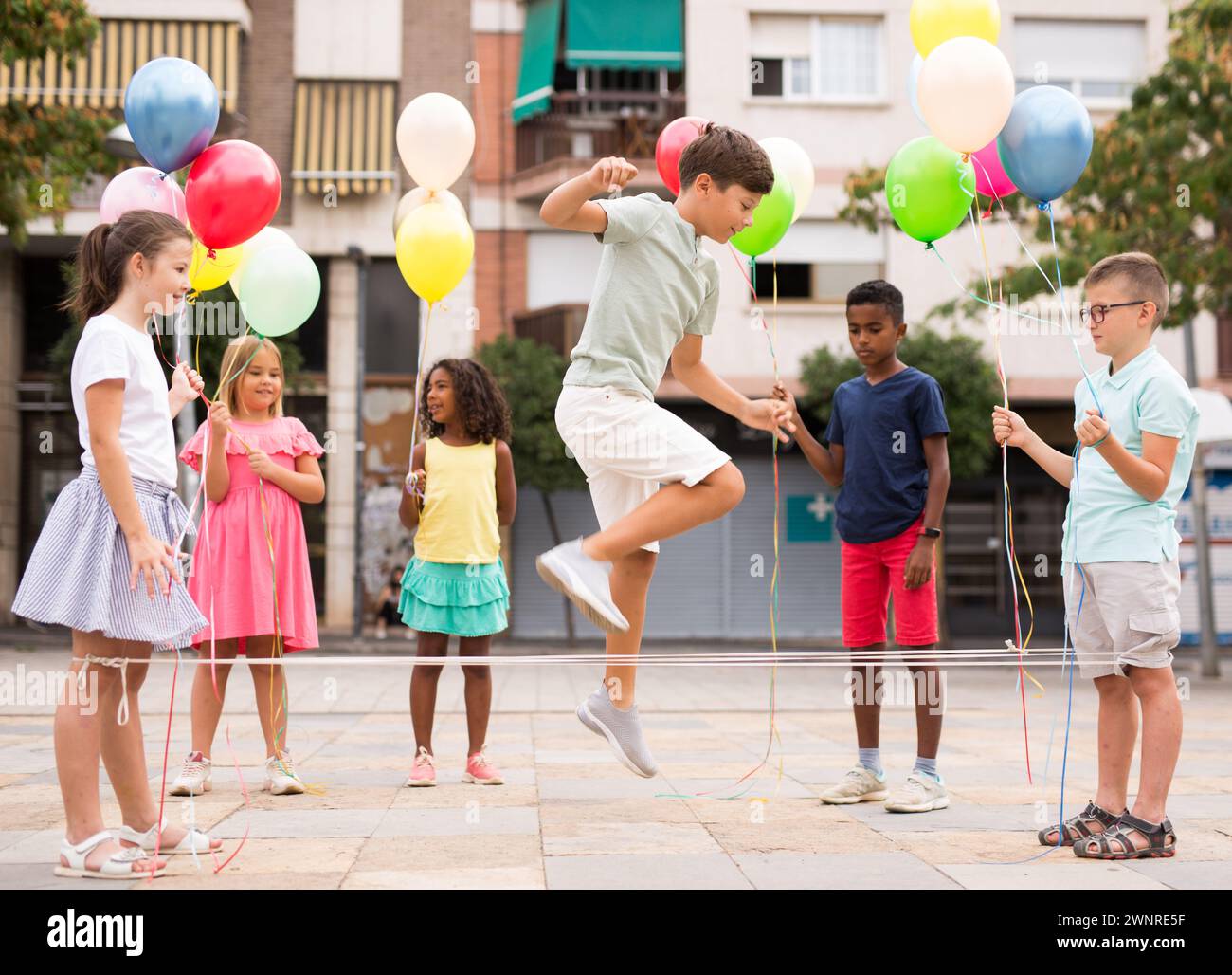 Kids playing together outdoors Stock Photo - Alamy